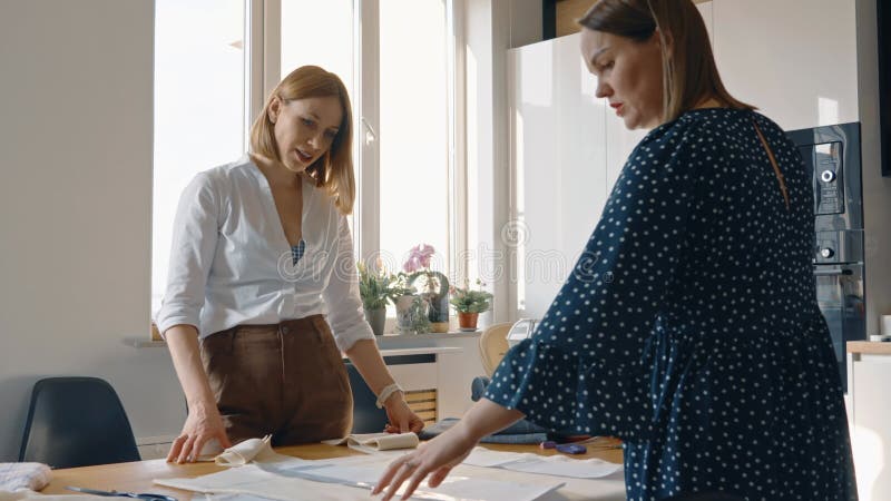 Two Women Collaborating in a Creative Sewing Project Stock Video ...