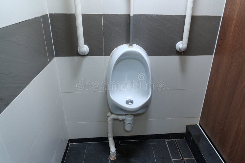 A Well-maintained Restroom Showcases a Single White Urinal Against a ...