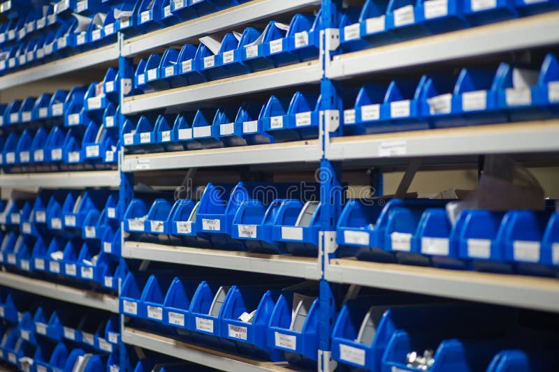 A Wellorganized Warehouse Featuring Blue Storage Bins for Improved ...
