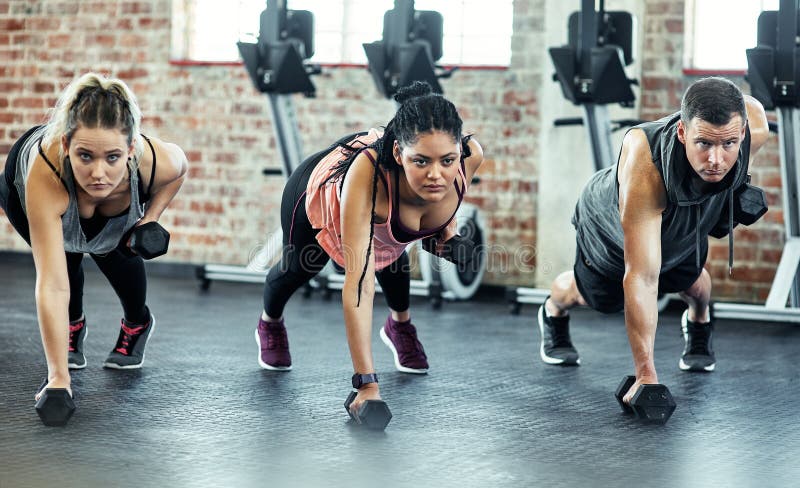 Were All Performing at the Same Level. a Fitness Group Using Dumbbells ...