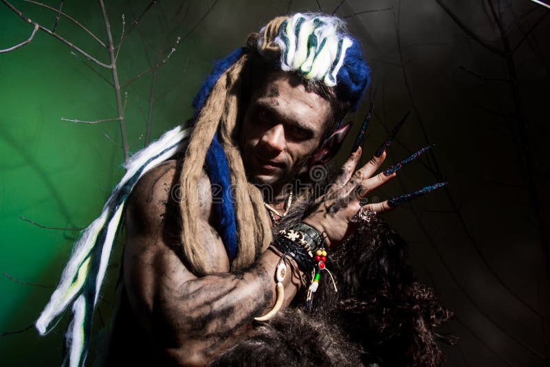 Werewolf with Long Nails among the Branches of the Tree and Smoke ...