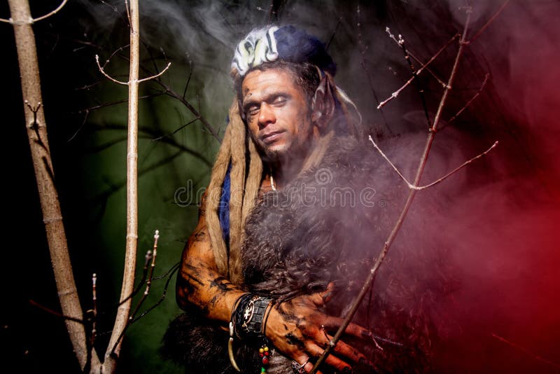 Werewolf with Long Nails and Hair Dreadlocks among the Branches Stock ...