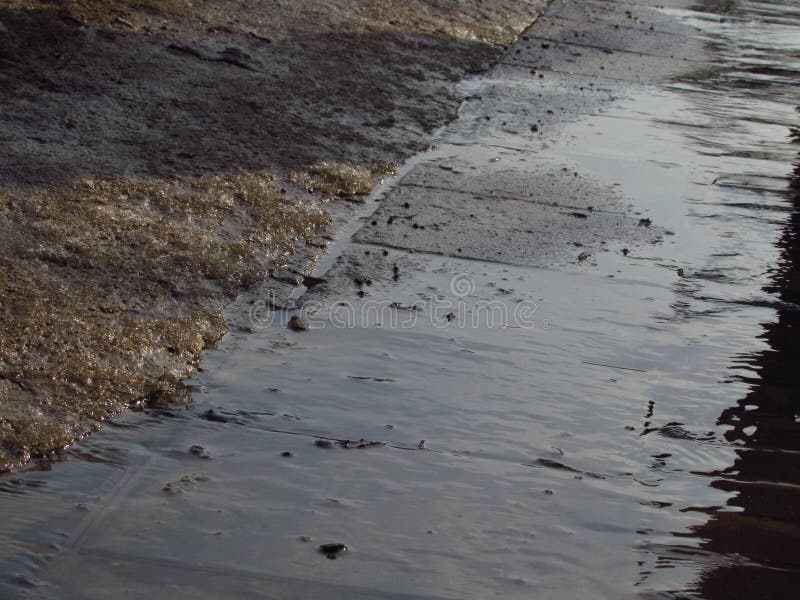 Wet Asphalt Path and Melting Dirty Snow on the Side of the Road Stock ...