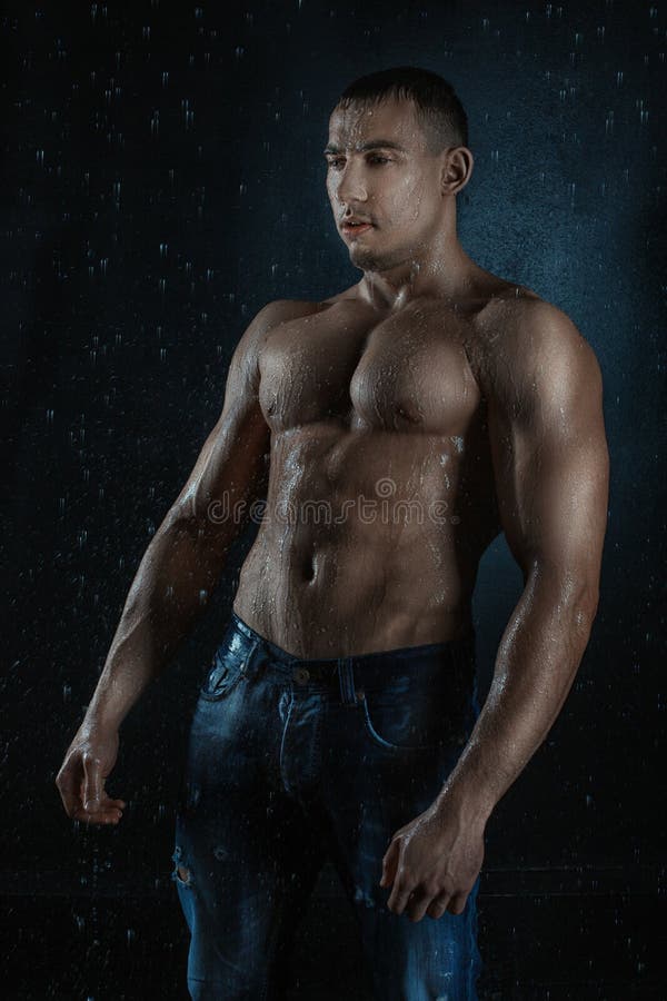 Bodybuilder in Rain Drinks Water from Hands Stock Photo - Image of ...