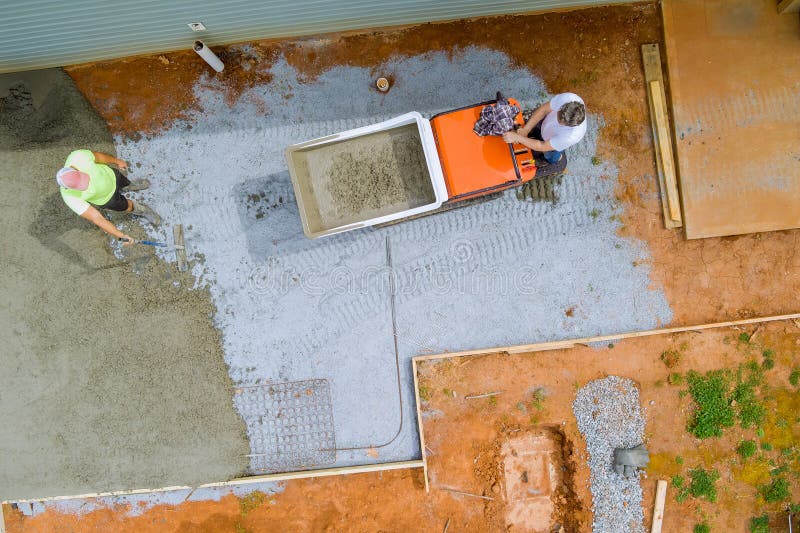 Wet Cement is Poured into Framework Using a Self Dumping Track Concrete ...