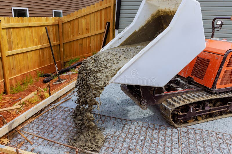 Wet Cement is Poured into Framework Using a Self Dumping Track Concrete ...