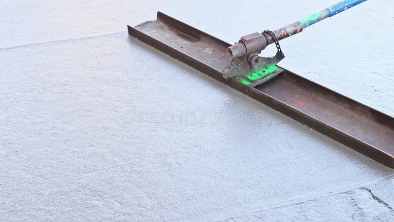 The Worker Was Pouring Concrete on the Sidewalk Using a Long Trowel on ...