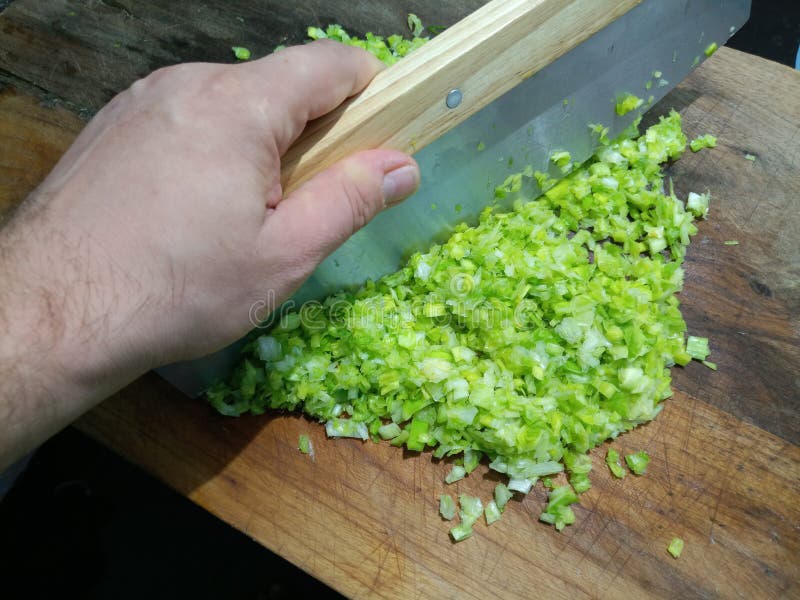 Male Hand with a Large Blade Dicing Celery Stock Image - Image of ...