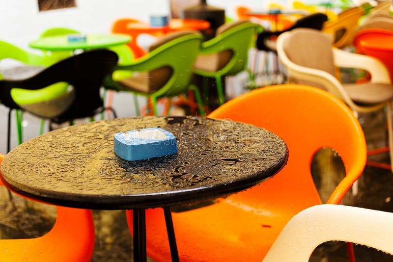 Wet coffee shop table stock photo. Image of chair, rain - 72837240