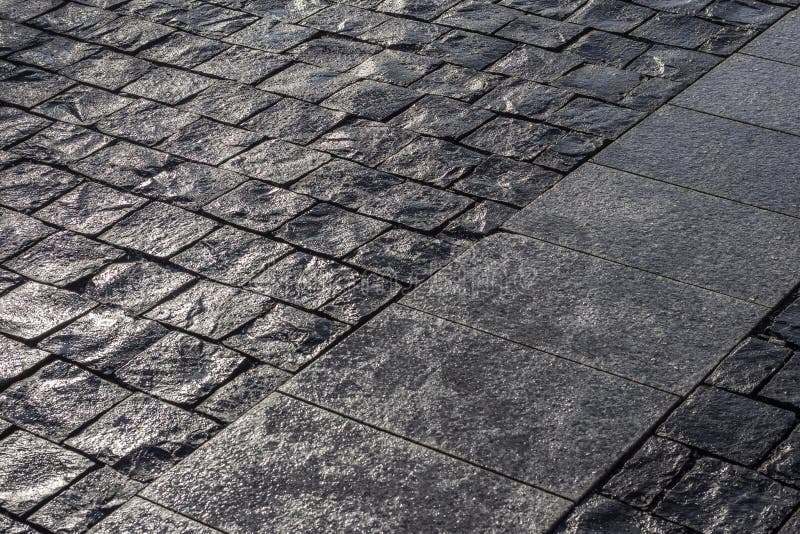 Wet Dark Basalt Paving in the Evening Light. Stock Image - Image of ...