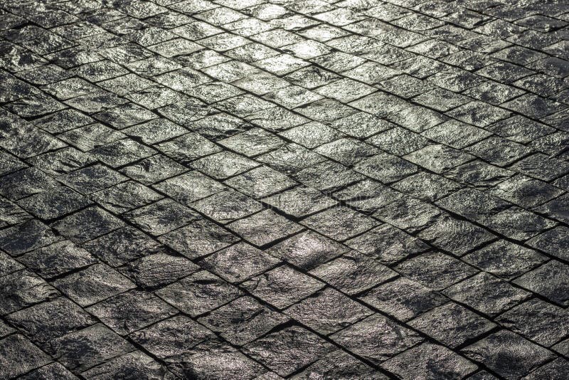 Wet Dark Basalt Paving Illuminated by Soft Light. Stock Image - Image ...