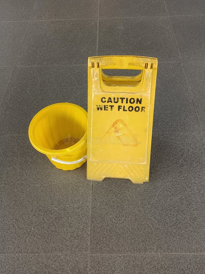 Wet Floor Warning Sign with Yellow Bucket Stock Photo - Image of ...