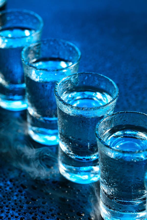 Wet Glasses of Vodka in Smoke on Dark Blue Background Stock Image ...