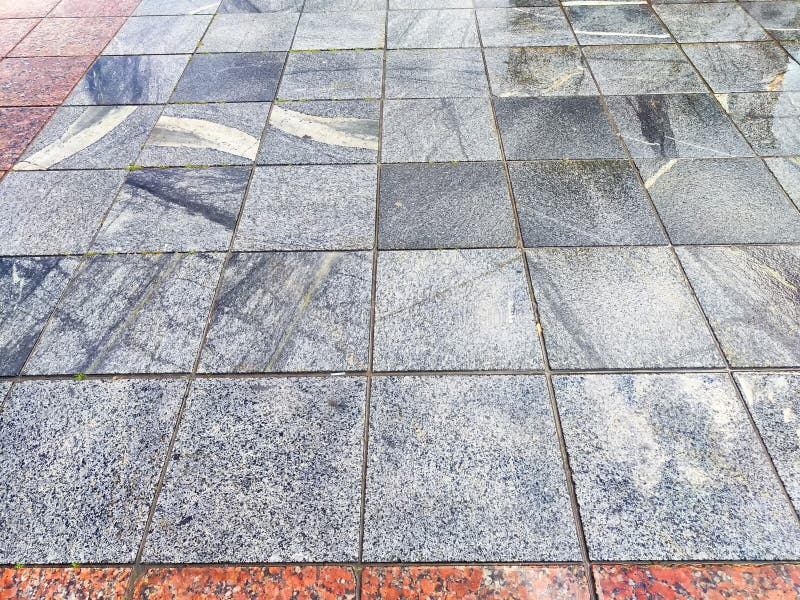 Wet Granite Pavement with Reflections of a Nearby Building after ...