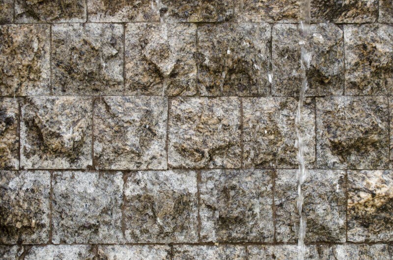 The Wet Grey Stone Bricks Wall with Running Water on it. Stock Image ...