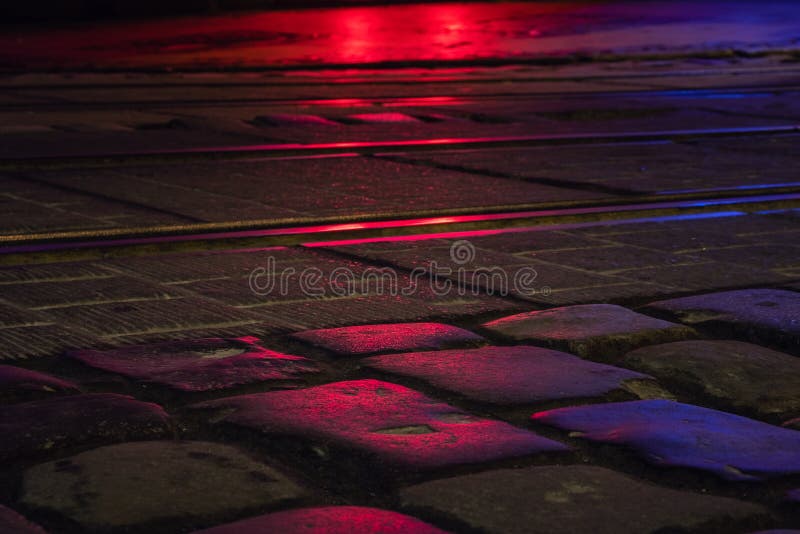 Illuminated by Red Light Cobblestone Street at Night Stock Photo ...