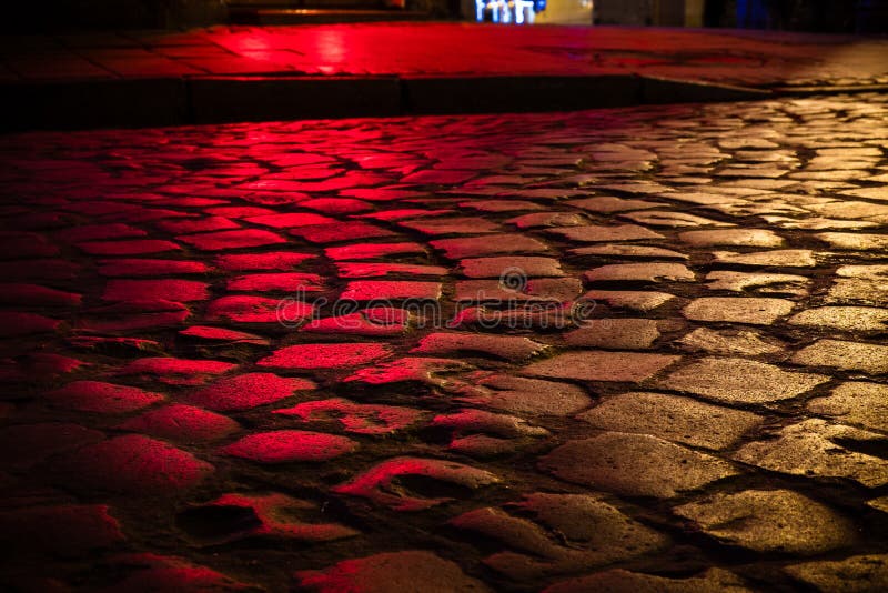 Illuminated by Red Light Cobblestone Street at Night Stock Image ...