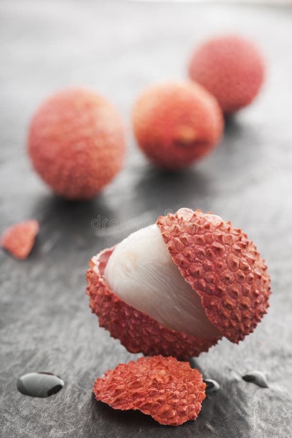 Wet lychee on slate stock image. Image of recording - 108628065