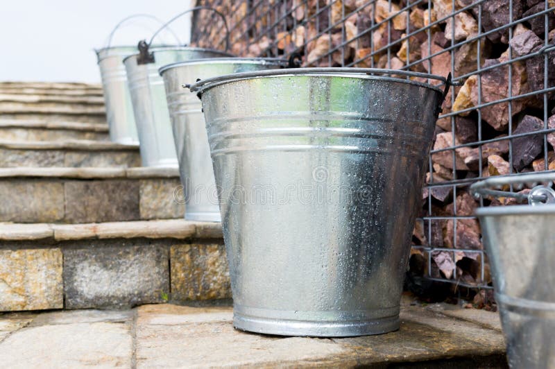 Wet Metal Buckets on Stairs Stock Photo - Image of household, clean ...