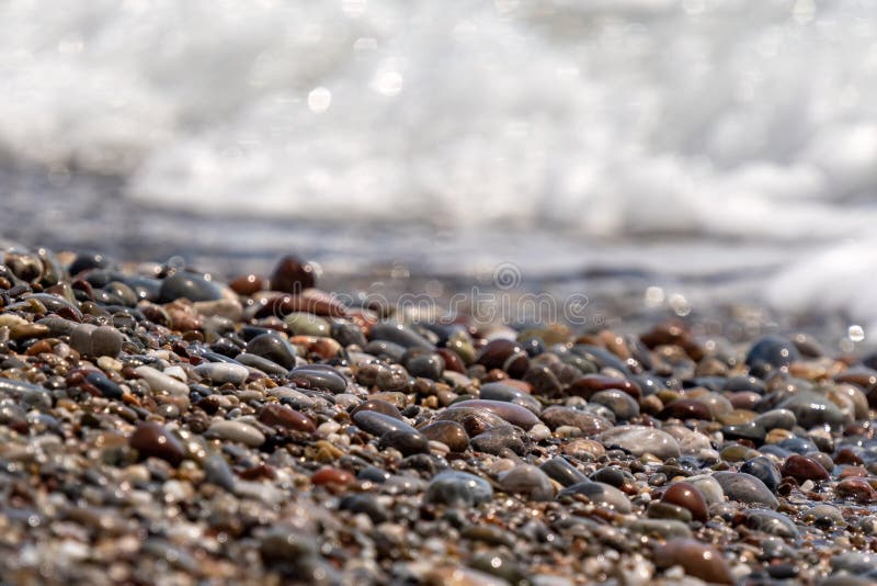 Wet pebbles by the sea stock photo. Image of background - 382301512