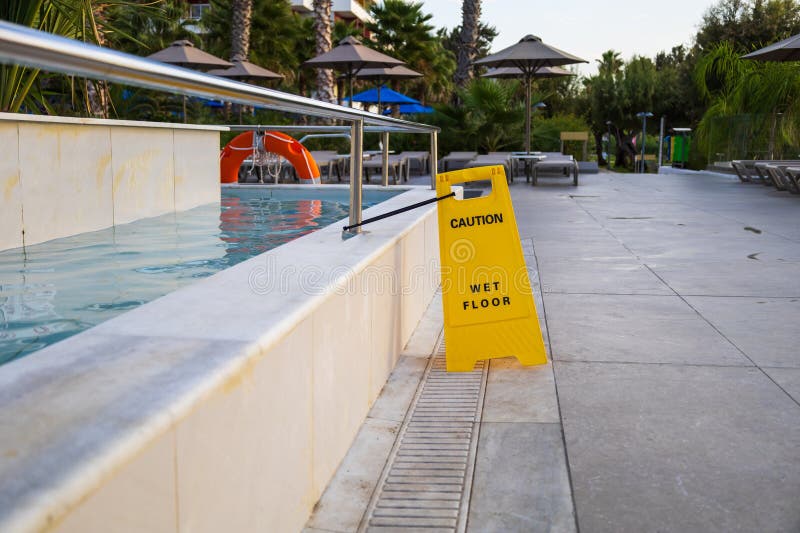 Wet Pool Floor Warning. Yellow Warning Sign with the Words Wet Floor ...