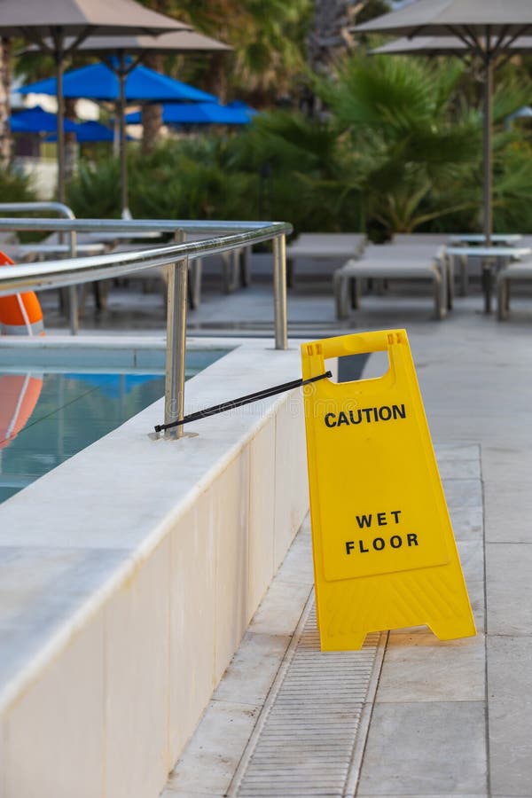 Wet Pool Floor Warning. Yellow Warning Sign with the Words Wet Floor ...