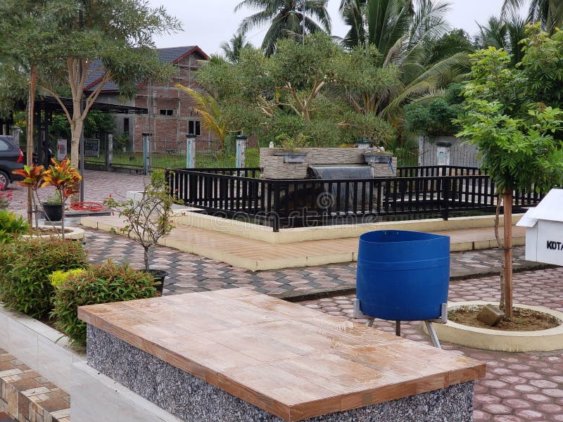 Wet Tile Patio with a Water Feature and a Blue Container Stock Image ...