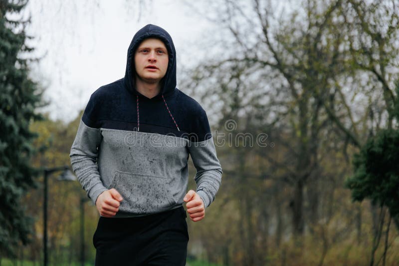 Wet Workout Athletic Man Running in the Rain for Cardio Training Stock ...