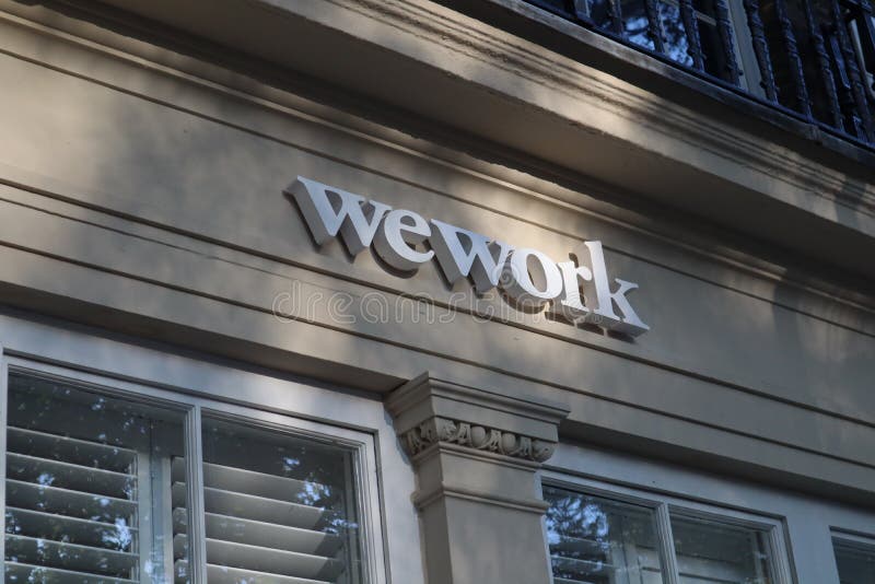 A Wework sign in shadows. editorial image. Image of delusion - 160107275