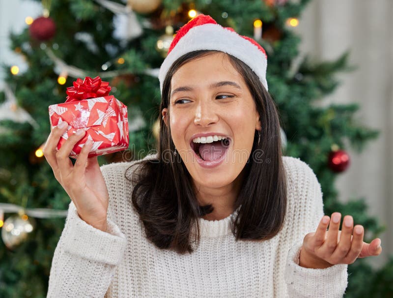 What Could it Be. a Young Woman Holding a Gift at Home. Stock Photo ...