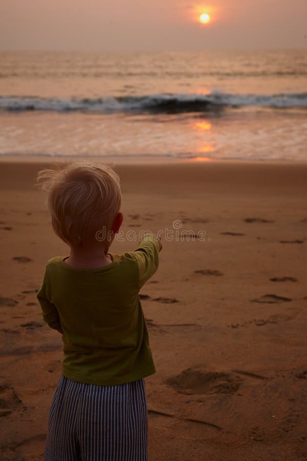 What Summer is for. Rearview of a Little Boy on a Beach at Sunset ...