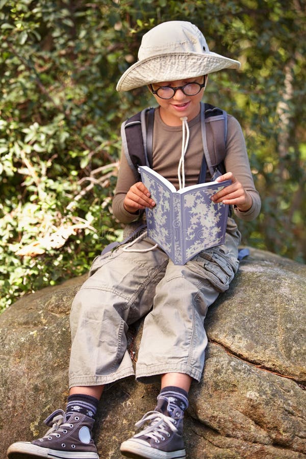 What Will I Discover Today. a Young Kid Reading a Book Outdoors. Stock ...
