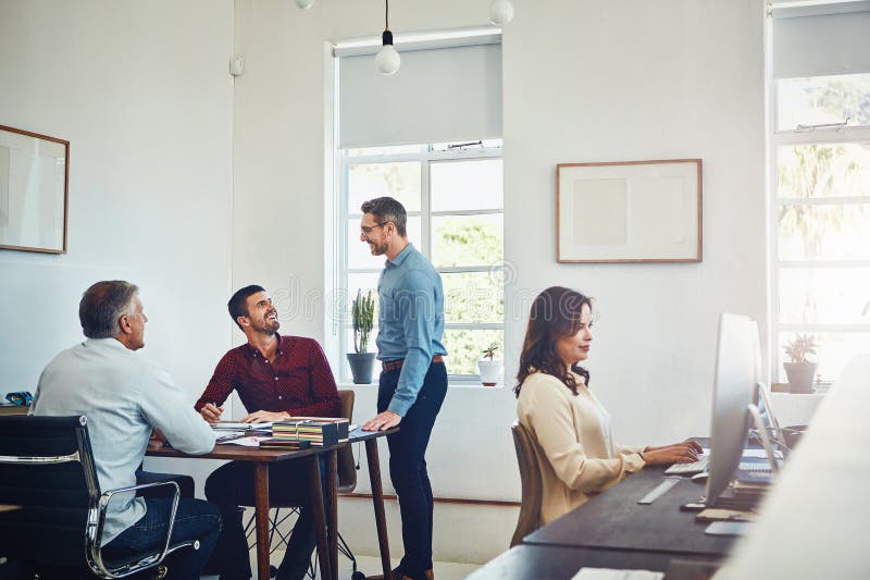 This is What a Working Office Looks Like. a Group of Colleagues Working ...
