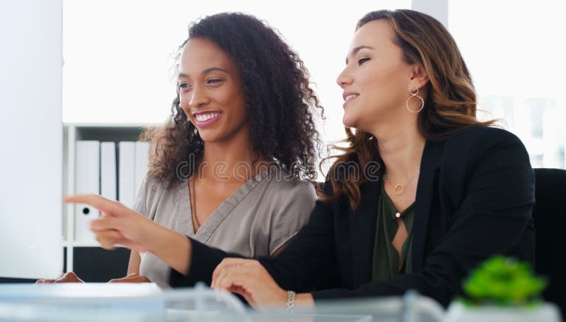 Whatever the Question, the Answer is Teamwork. Two Young Businesswomen ...