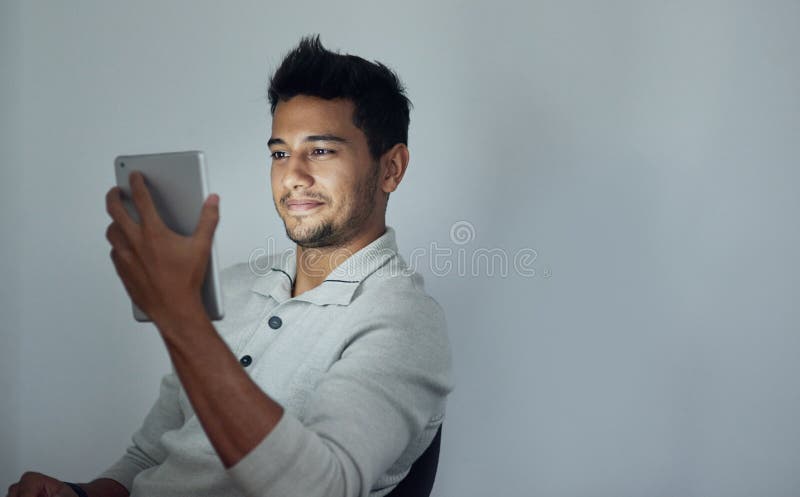 Whats the Latest on Social Media. a Young Man Using His Tablet at Night ...