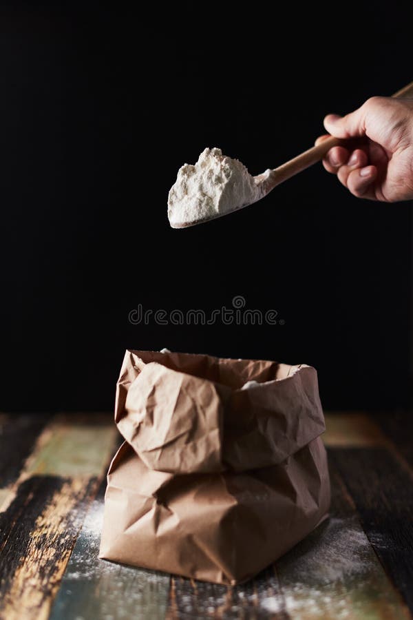 Wheat Flour in a Craft Package. Freeze Movement, Spoon Dark Background ...