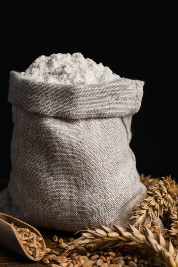 Wheat Flour in Sack Bag, Spikes and Grains on Wooden Table Stock Image ...