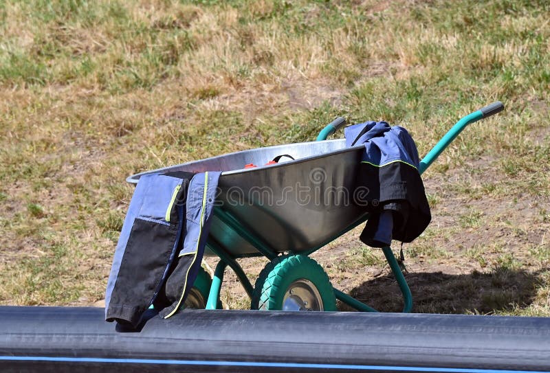 Wheel Barrow and Pipe on Construction Stock Photo - Image of ...