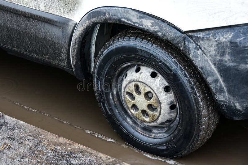 The Wheel of a Car in a Puddle in the Spring during the Melting of Snow ...