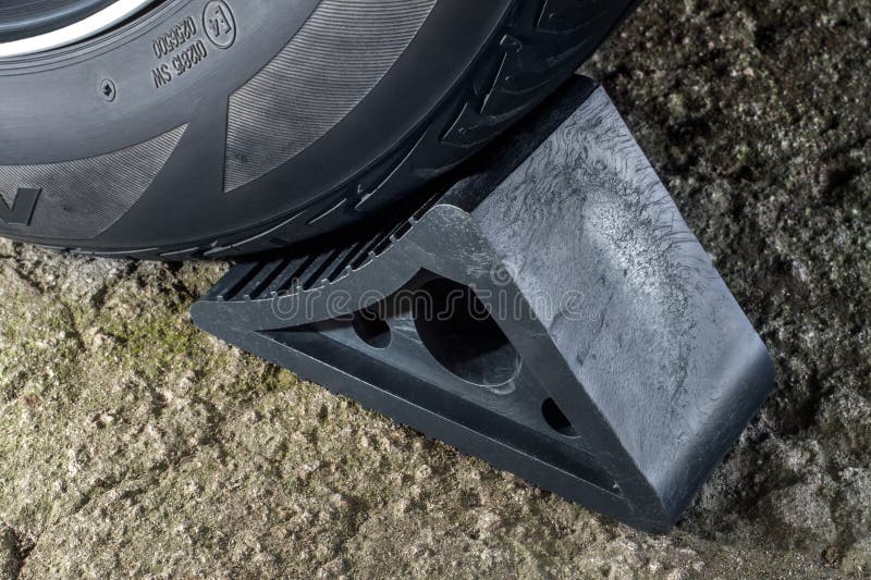 Wheel Chocks Under the Wheel of the Car. Stock Photo - Image of street ...