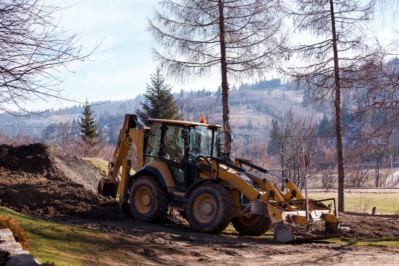 Wheel Excavator Loader is Digging the Soil at the Construction Site ...