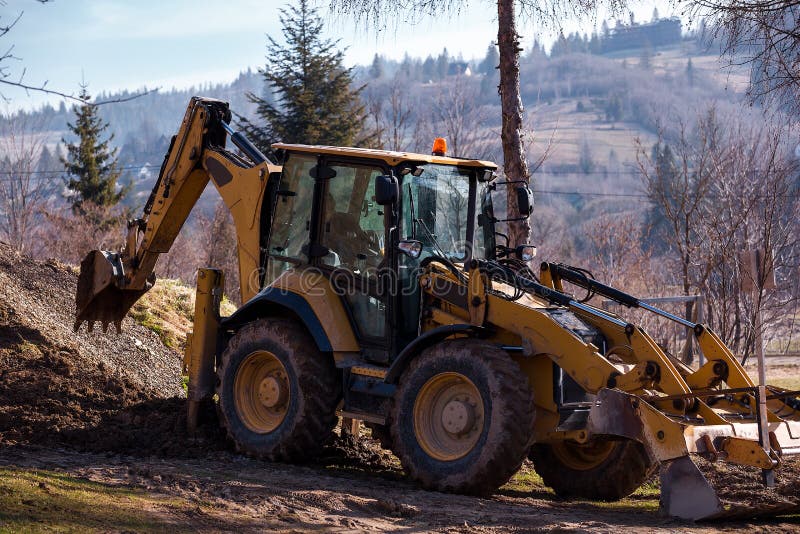 Wheel Excavator Loader is Digging the Soil at the Construction Site ...