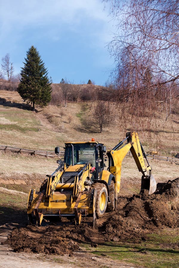 Wheel Excavator Loader is Digging the Soil at the Construction Site ...