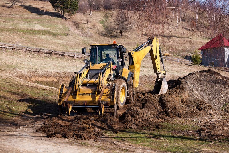 Wheel Excavator Loader is Digging the Soil at the Construction Site ...