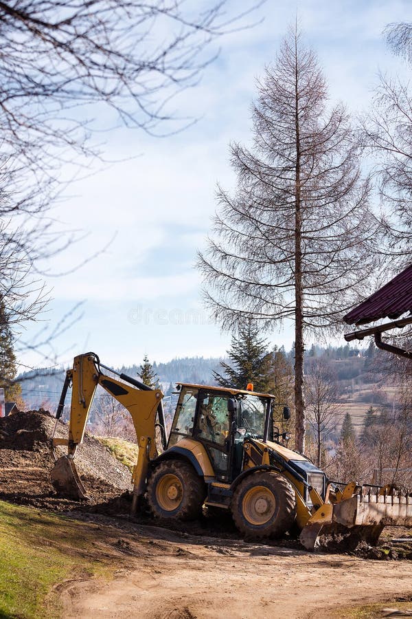 Wheel Excavator Loader is Digging the Soil at the Construction Site ...