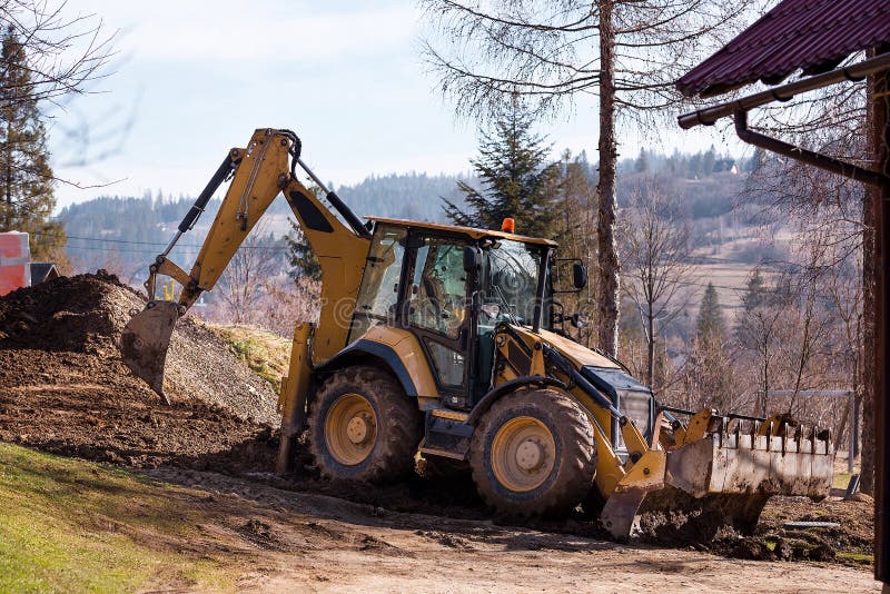 Wheel Excavator Loader is Digging the Soil at the Construction Site ...