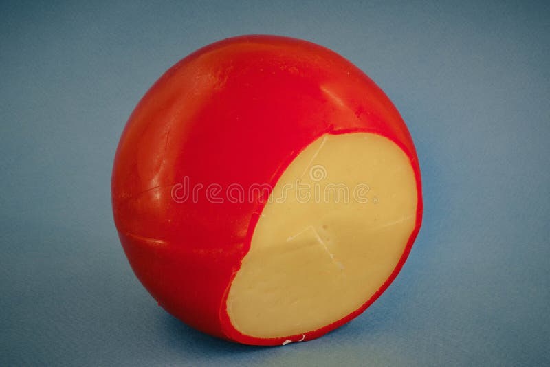 Wheel of Fresh Gouda Cheese with a Red Rind on a Blue Monophonic ...