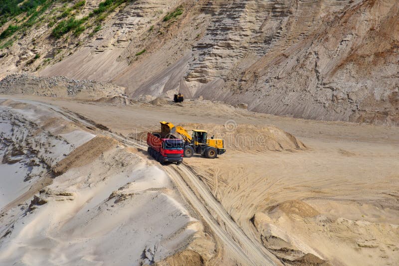 Wheel Front-end Loader Loading Sand into Heavy Dump Truck at the ...