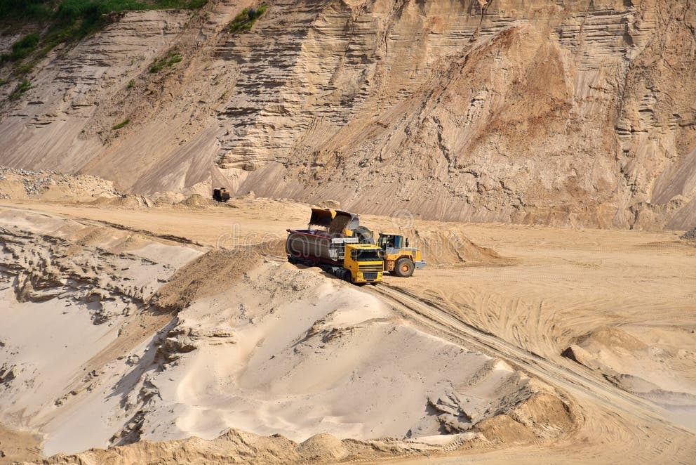 Wheel Front-end Loader Loading Sand into Heavy Dump Truck at the ...