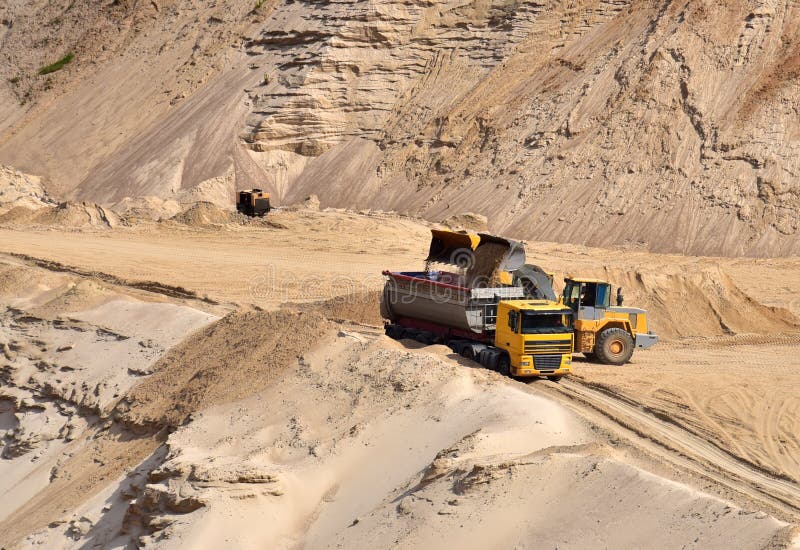 Wheel Front-end Loader Loading Sand into Heavy Dump Truck at the ...